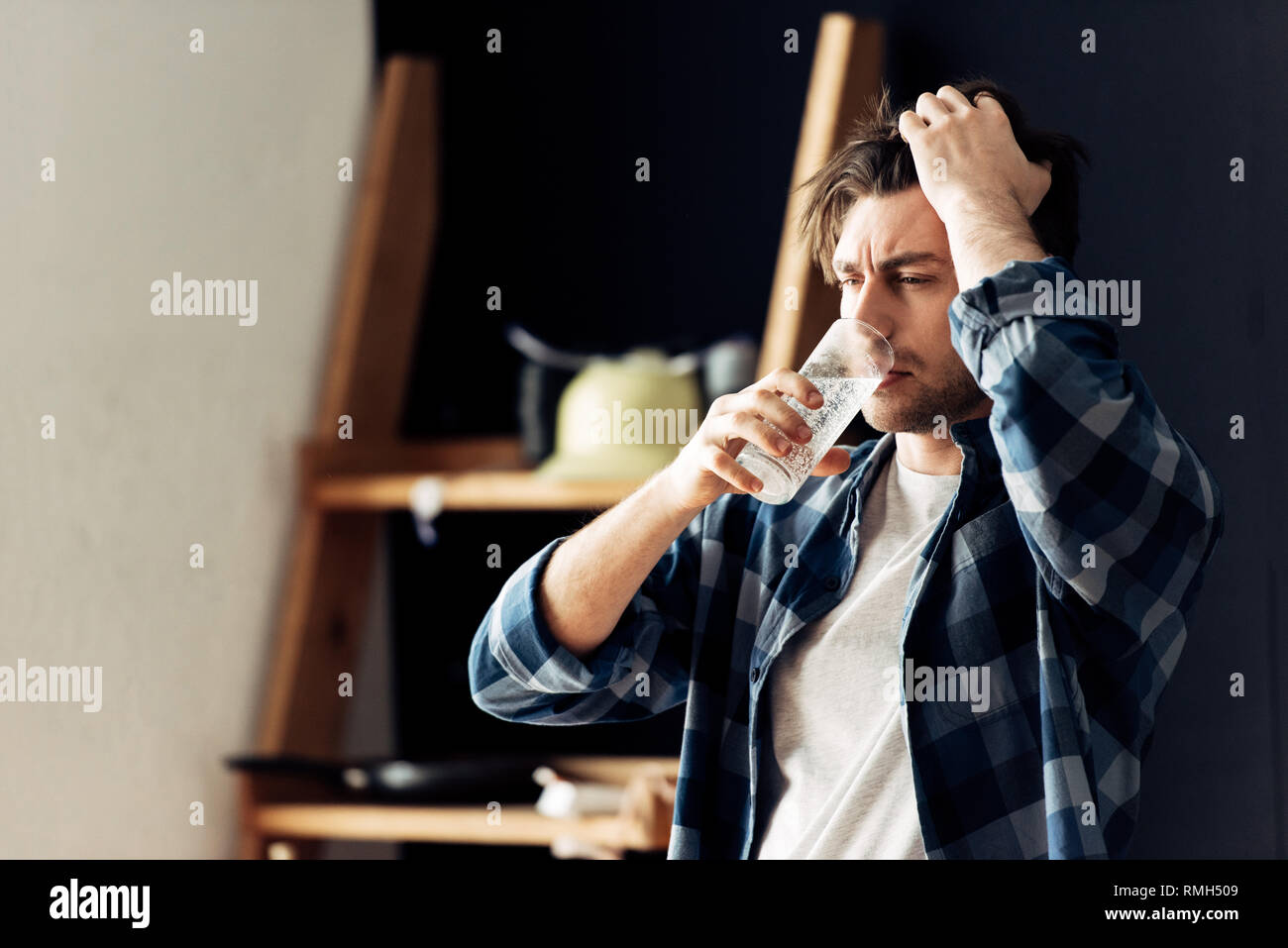 drunk man holding glass and drinking water after party Stock Photo - Alamy