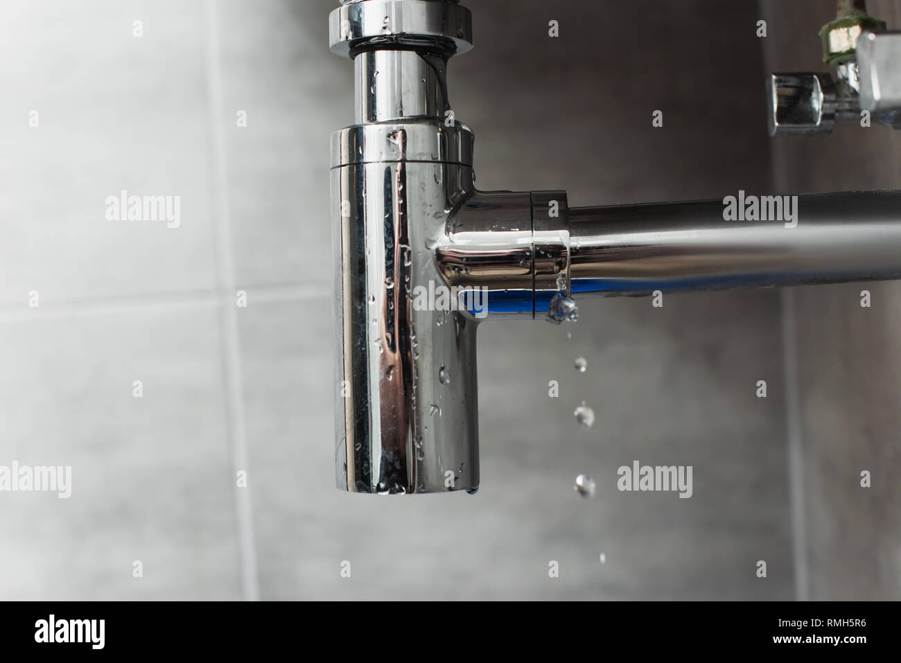 Steel shiny pipe with water drops on grey background Stock Photo - Alamy