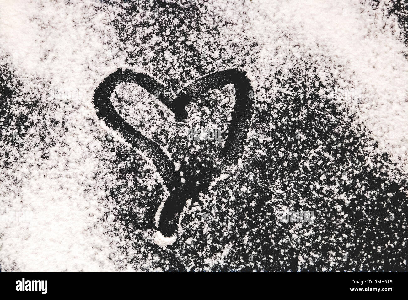 Baking background with heart shape and flour on the dark table. Copy ...