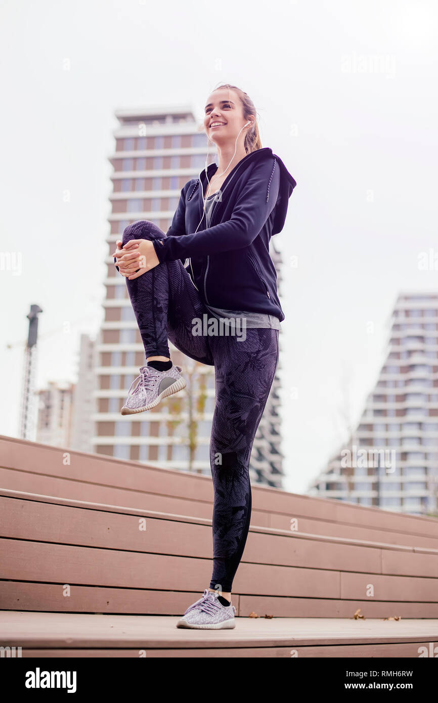 Woman performs stretching before jogging outdoor Stock Photo - Alamy