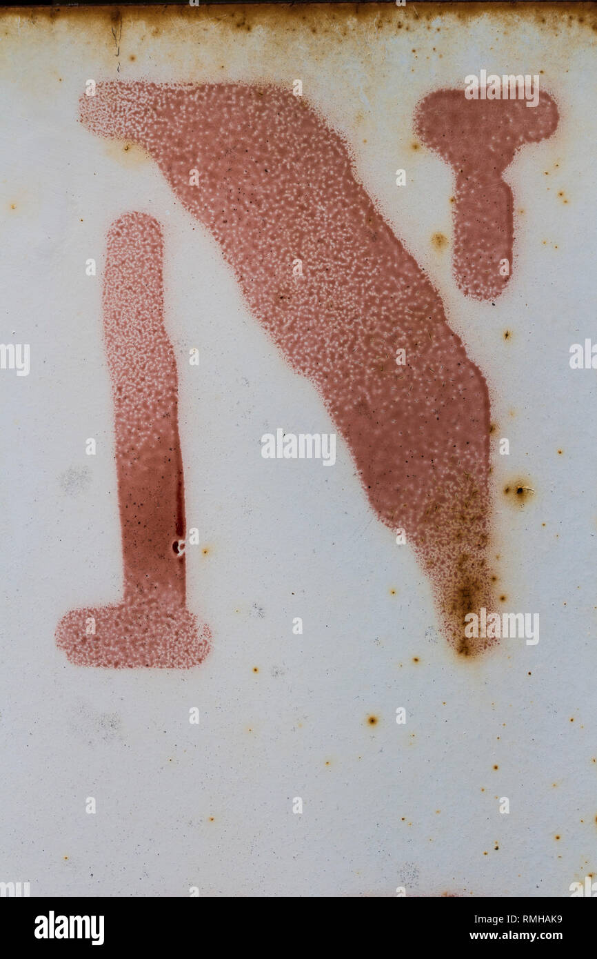 letter N painted on grungy surface, isolated, red letter, white ...