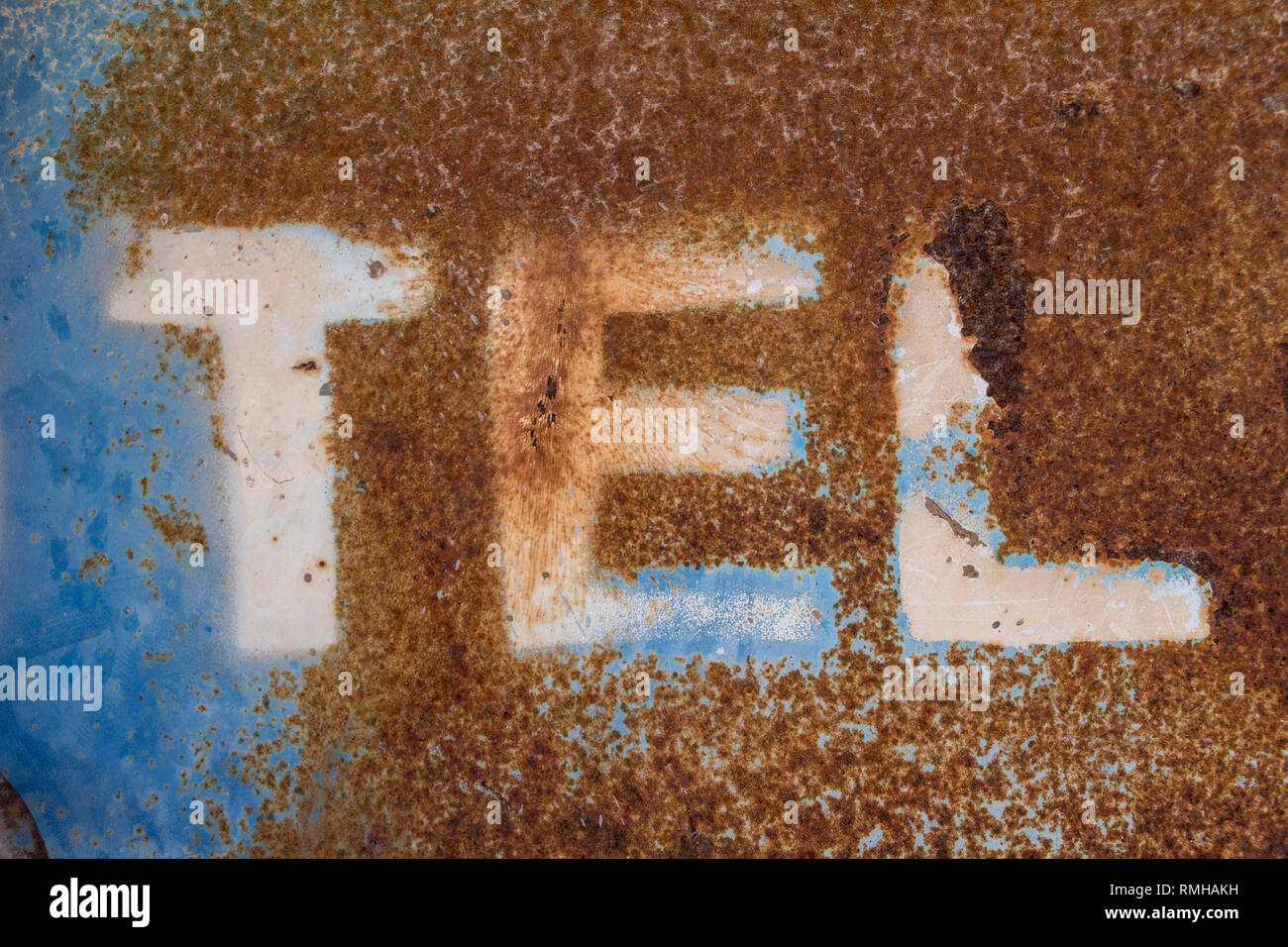 letters on rusty metal, letter T, letter E, letter L, word on over blue ...
