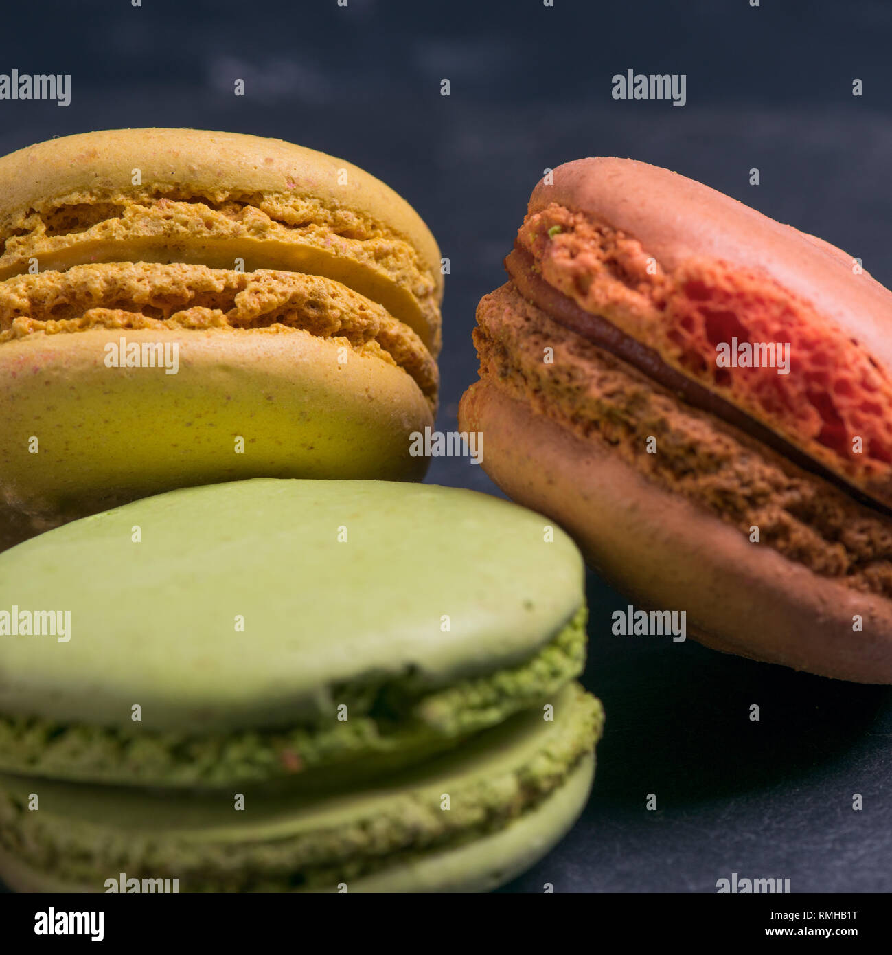 Photo in a dark key French sweet multi-colored macaroni Stock Photo - Alamy