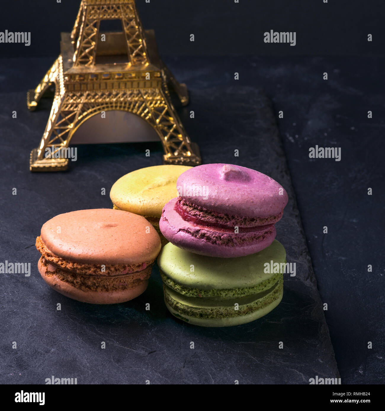 Photo in a dark key French sweet multi-colored macaroni Stock Photo - Alamy