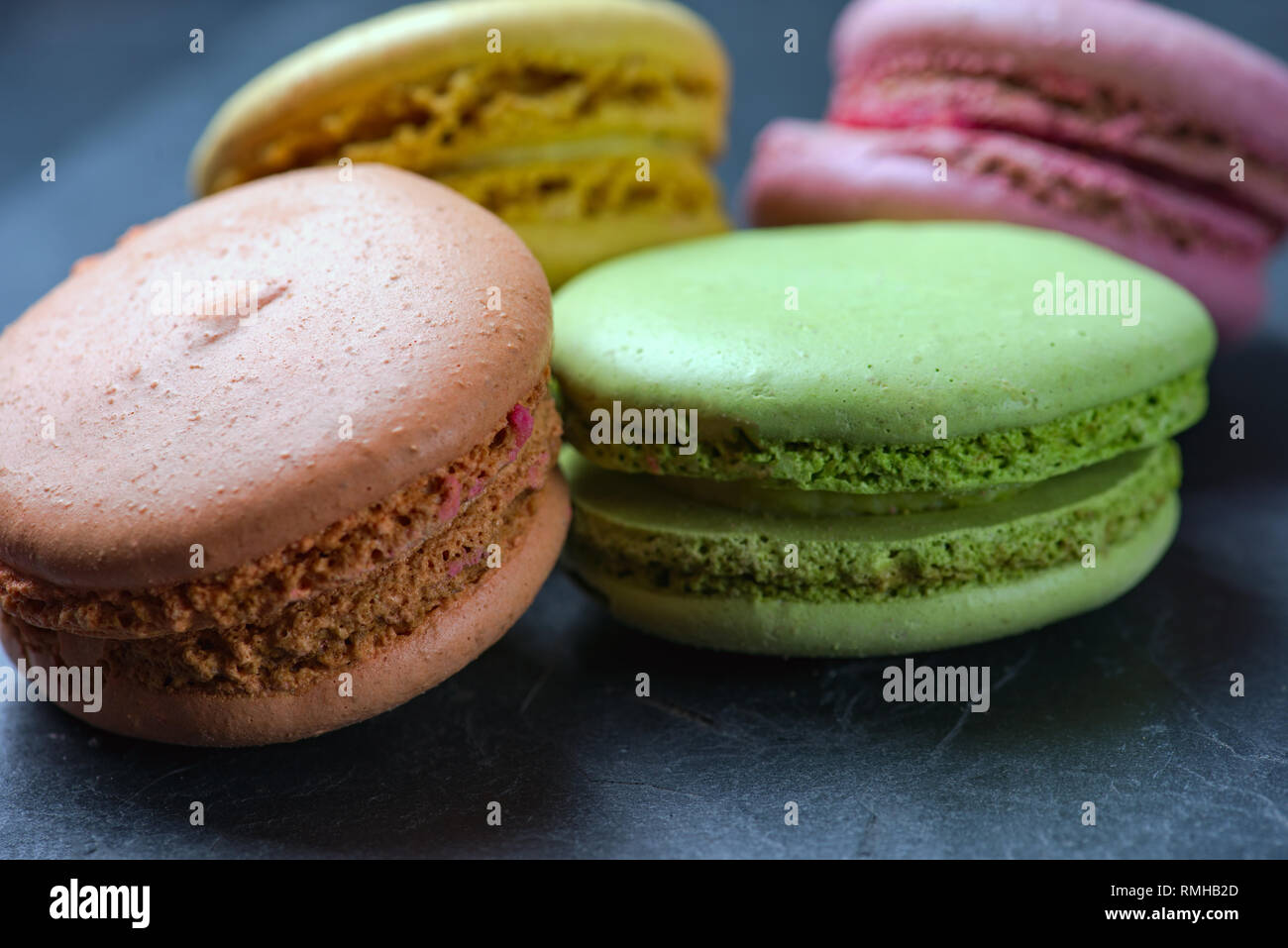 Photo in a dark key French sweet multi-colored macaroni Stock Photo - Alamy