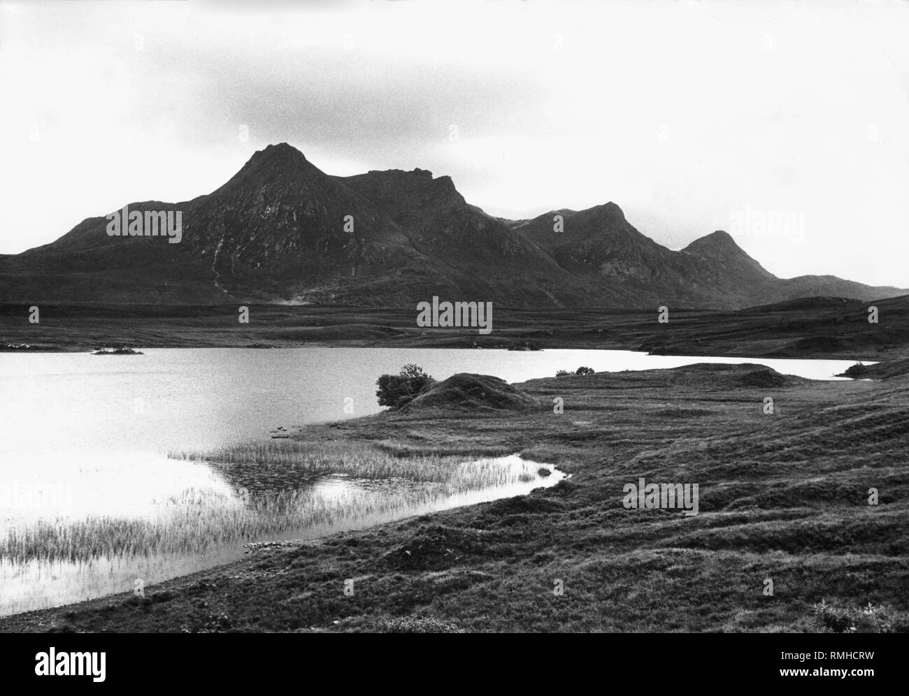 A landscape with a lake and a chain of hills in the county Sutherland ...