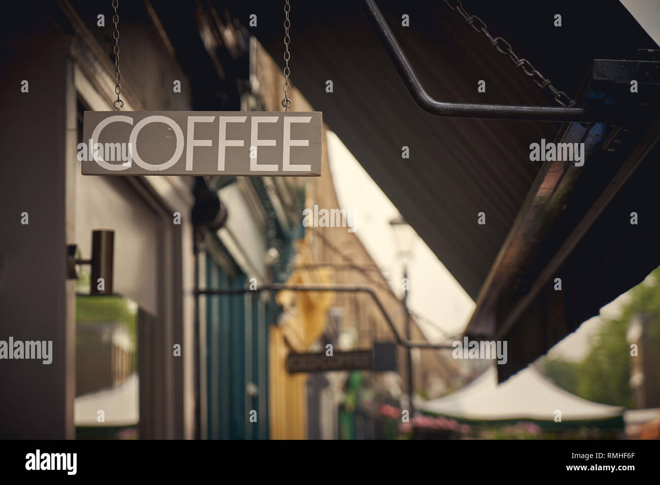 A Scandinavian design wooden coffee sign hanging outside a shop with ...