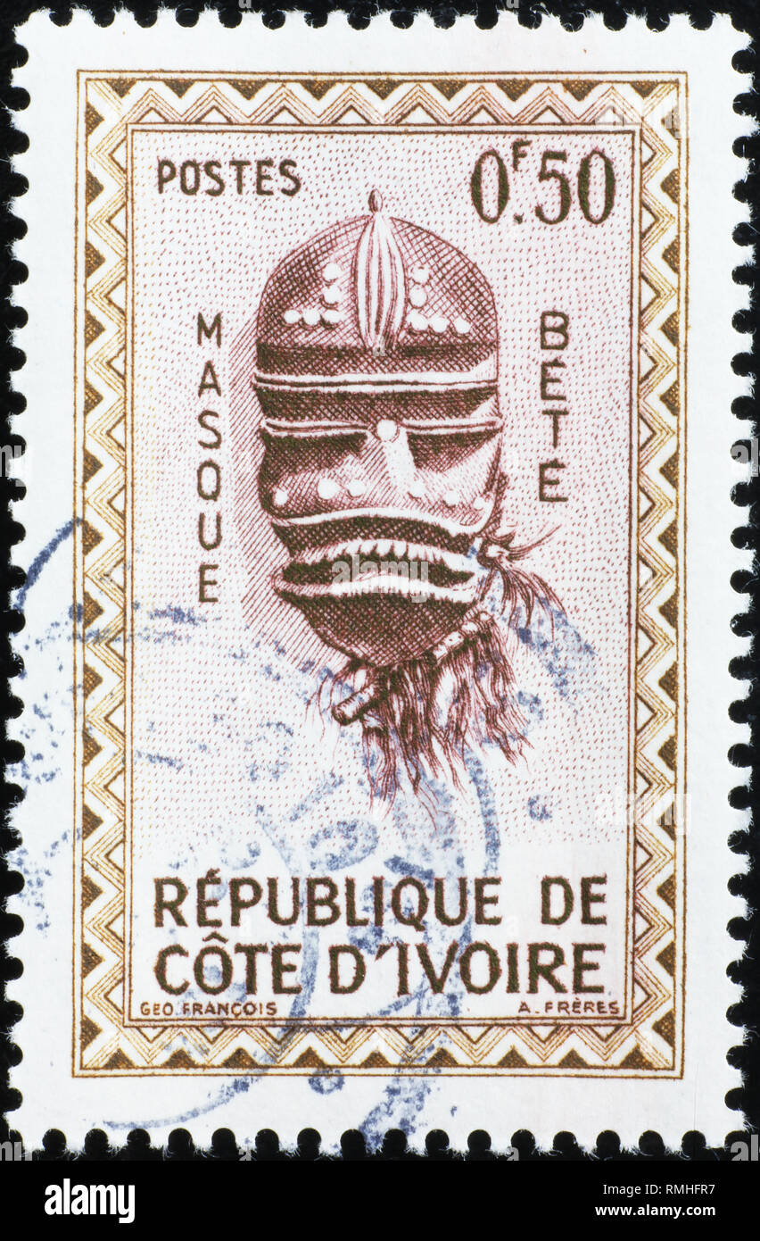 Mask of a beast on african postage stamp Stock Photo - Alamy