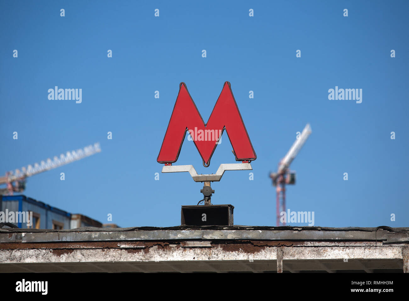 Sign indicating entrance to the Moscow metro station over blue ...
