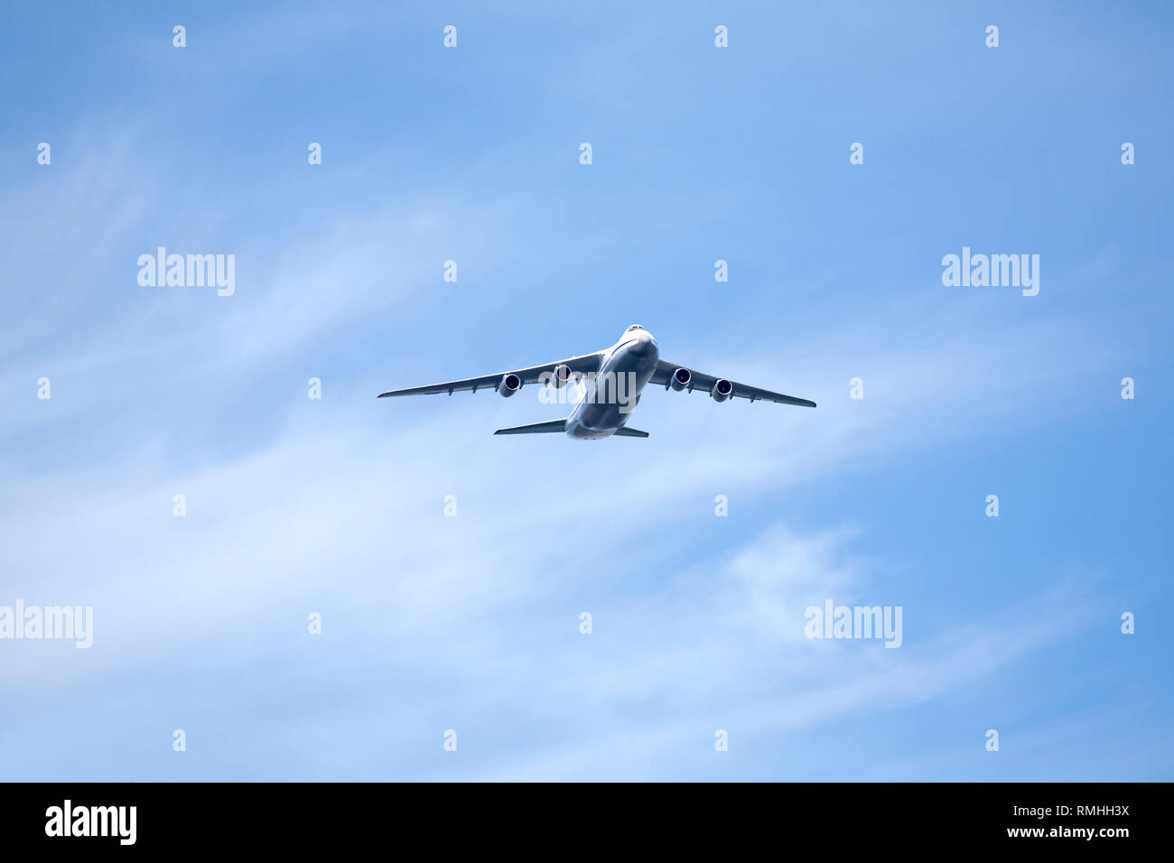 Large four engine jet transport aircraft flying high in clear blue sky ...