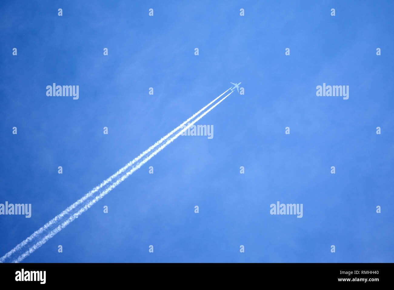 Large passenger supersonic plane flying high in blue sky with haze ...