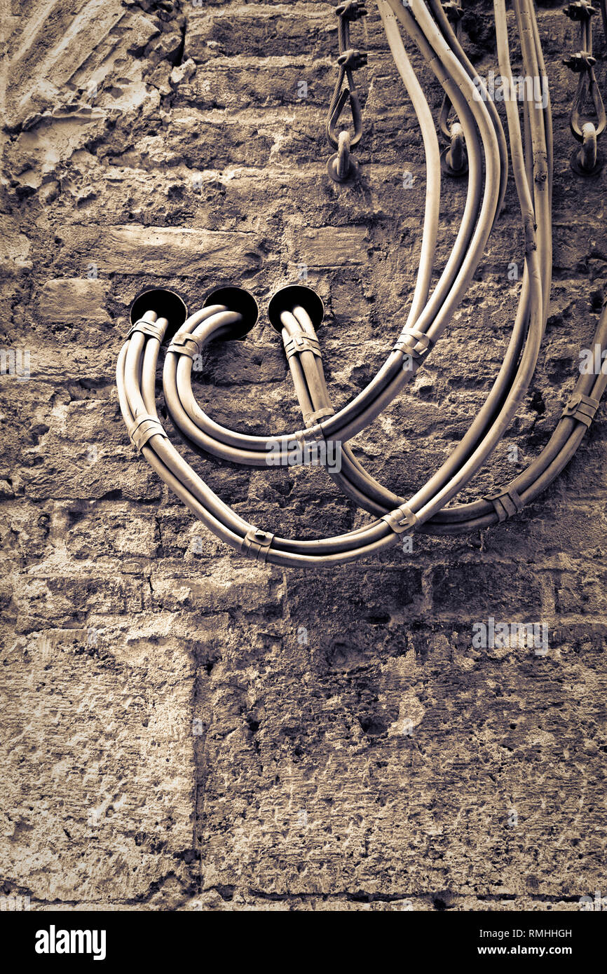 Electrical cables fixed on the wall for the distribution of electricity ...