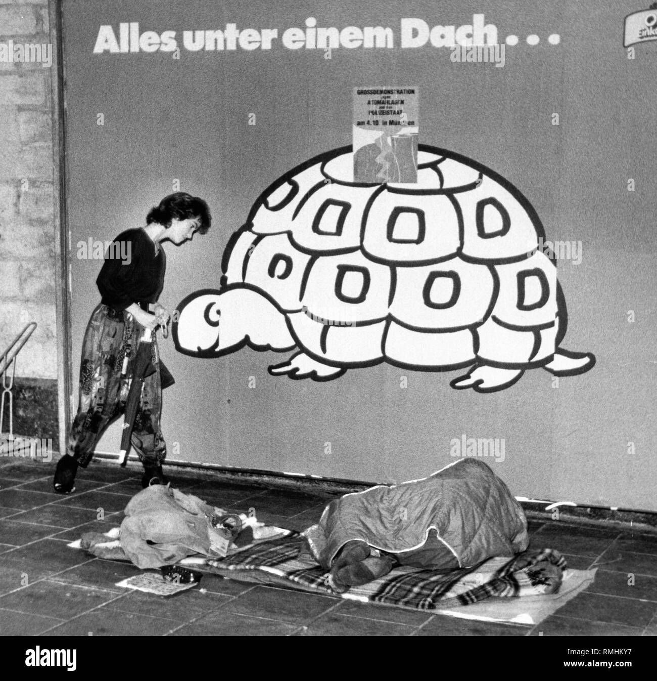 A woman with umbrella and a homeless person at the Stachus-Basement in ... A woman with umbrella and a homeless person at the Stachus-Basement in ...