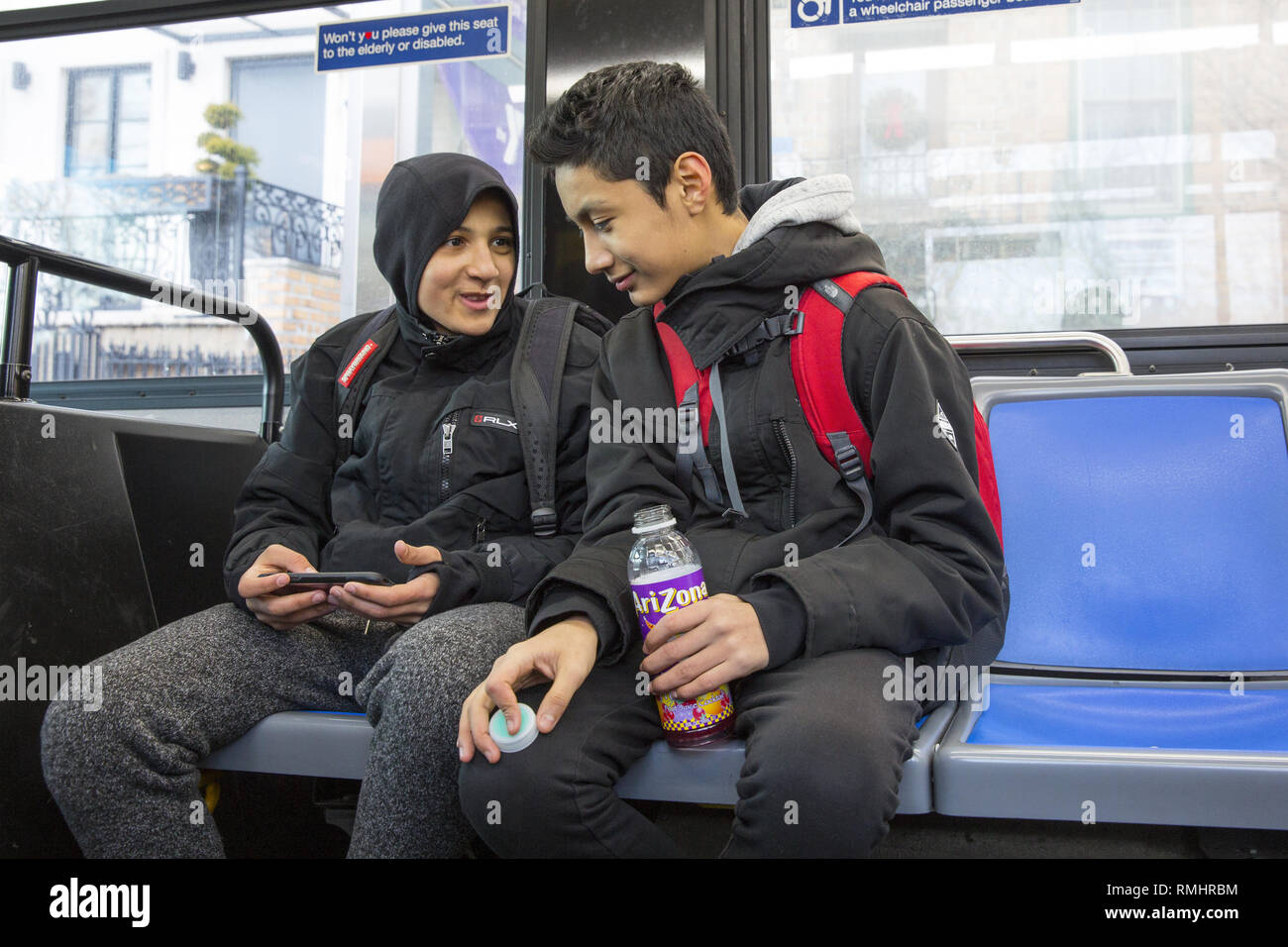 Adolescent boys ride a city bus together after school in Brooklyn, New ...