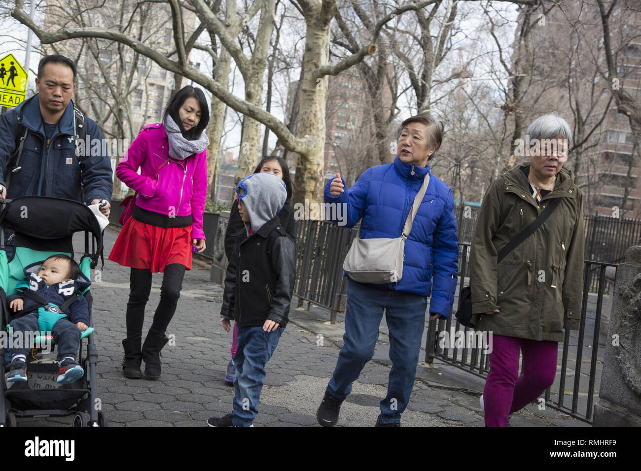 Chinese family walks together on the street in the Chinatown ...