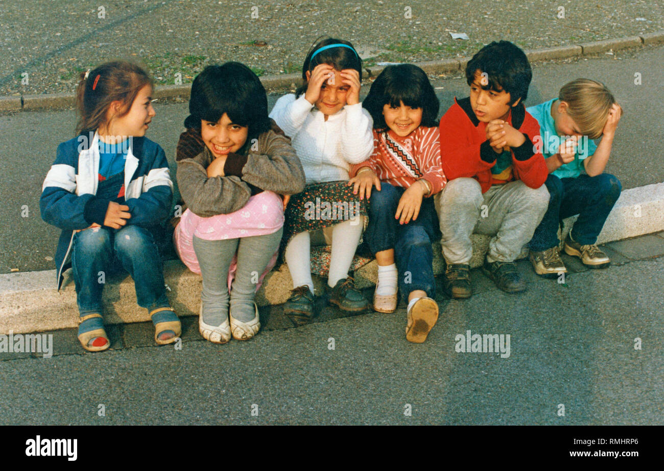 Children with Turkish roots sit on a curb Stock Photo - Alamy