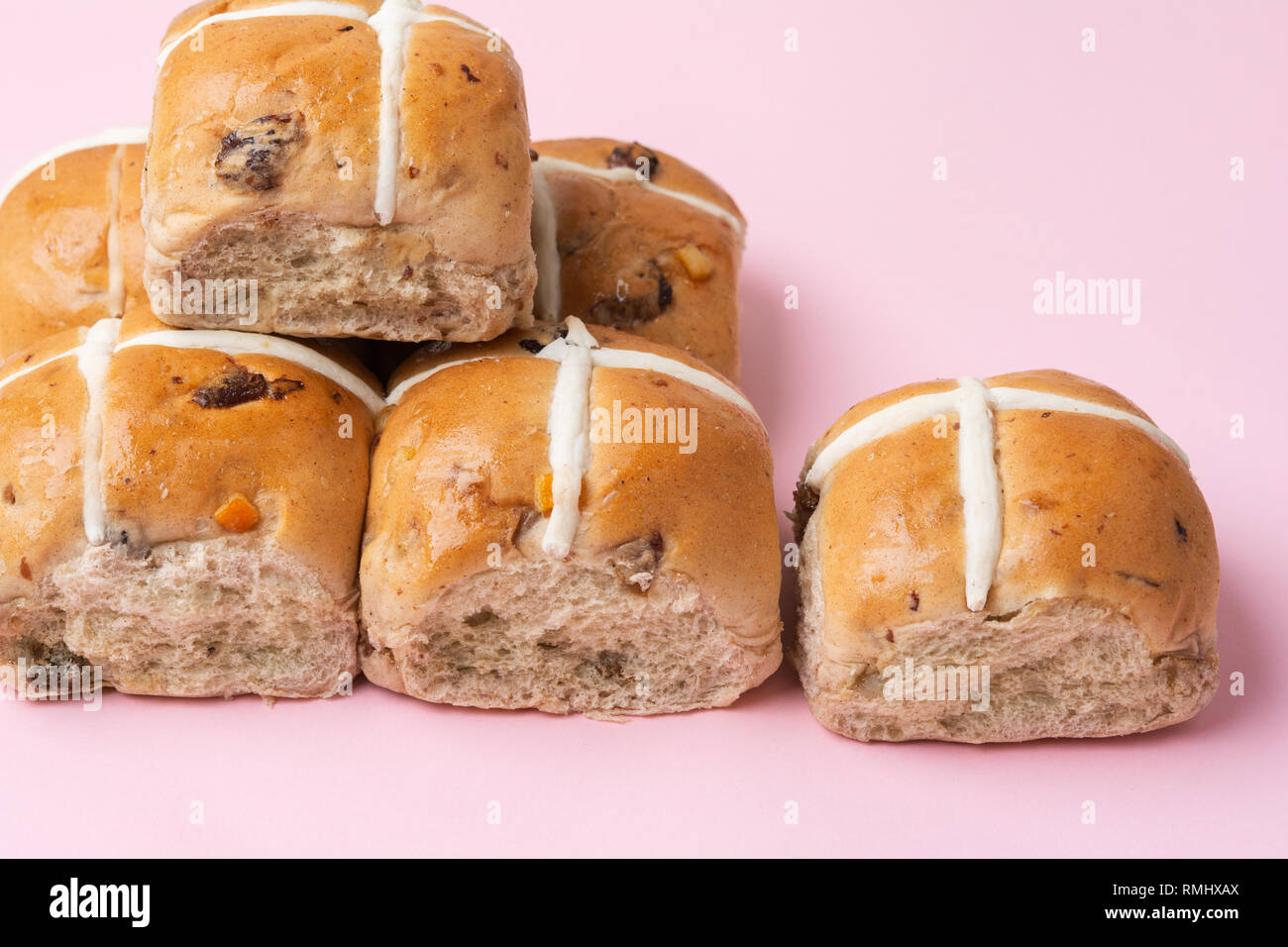 Six hot cross buns, traditional British Easter food on pink background ...