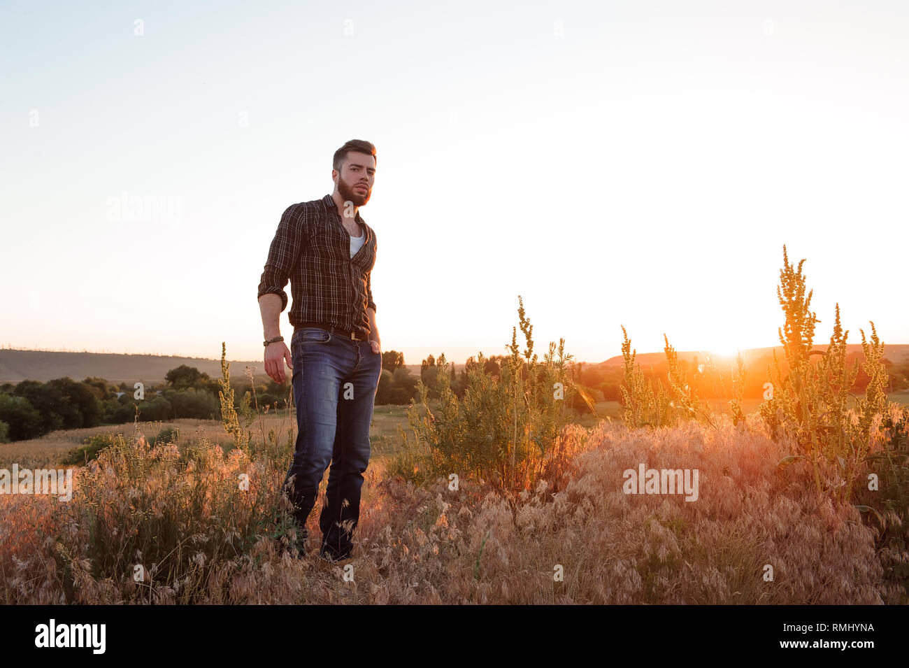 Handsome sports man on sunset background outdoors Stock Photo - Alamy