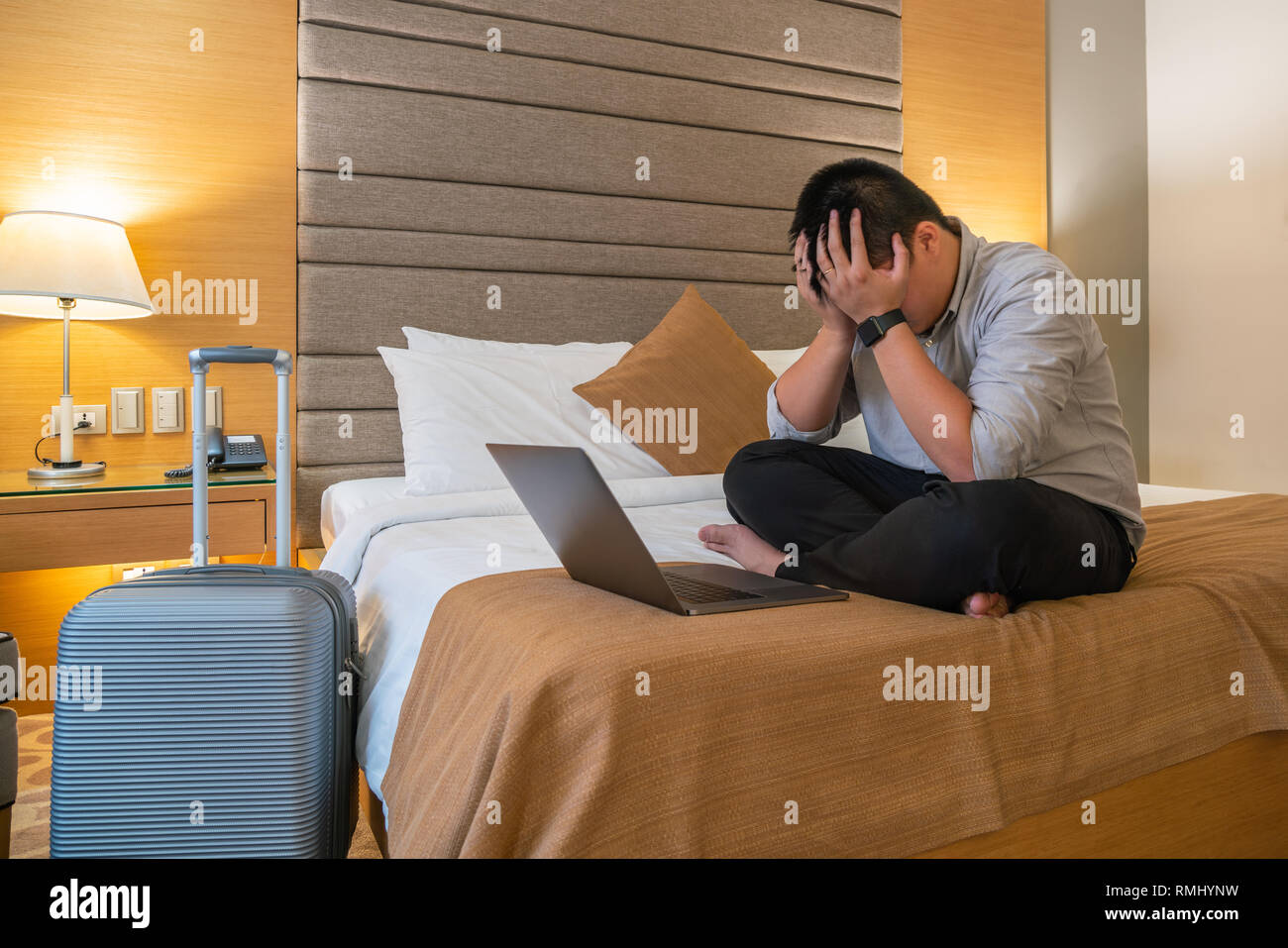 Businessman feel tired and stressed in hotel room Stock Photo - Alamy