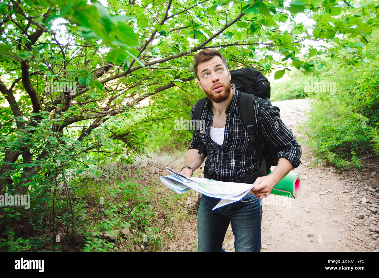 Young Man Traveler with map backpack relaxing outdoor Stock Photo - Alamy