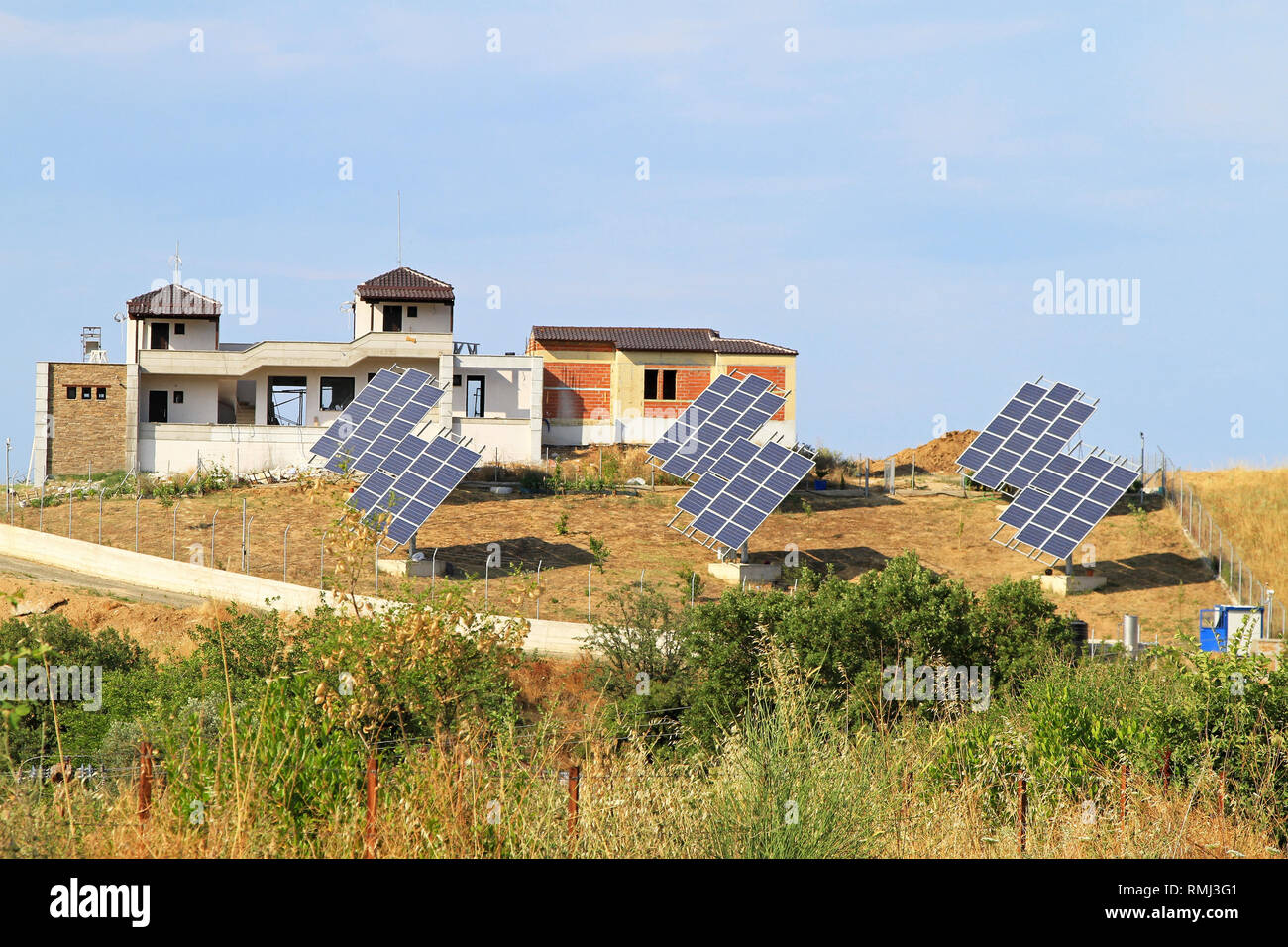 Solar modules system and new houses in rural area Stock Photo - Alamy