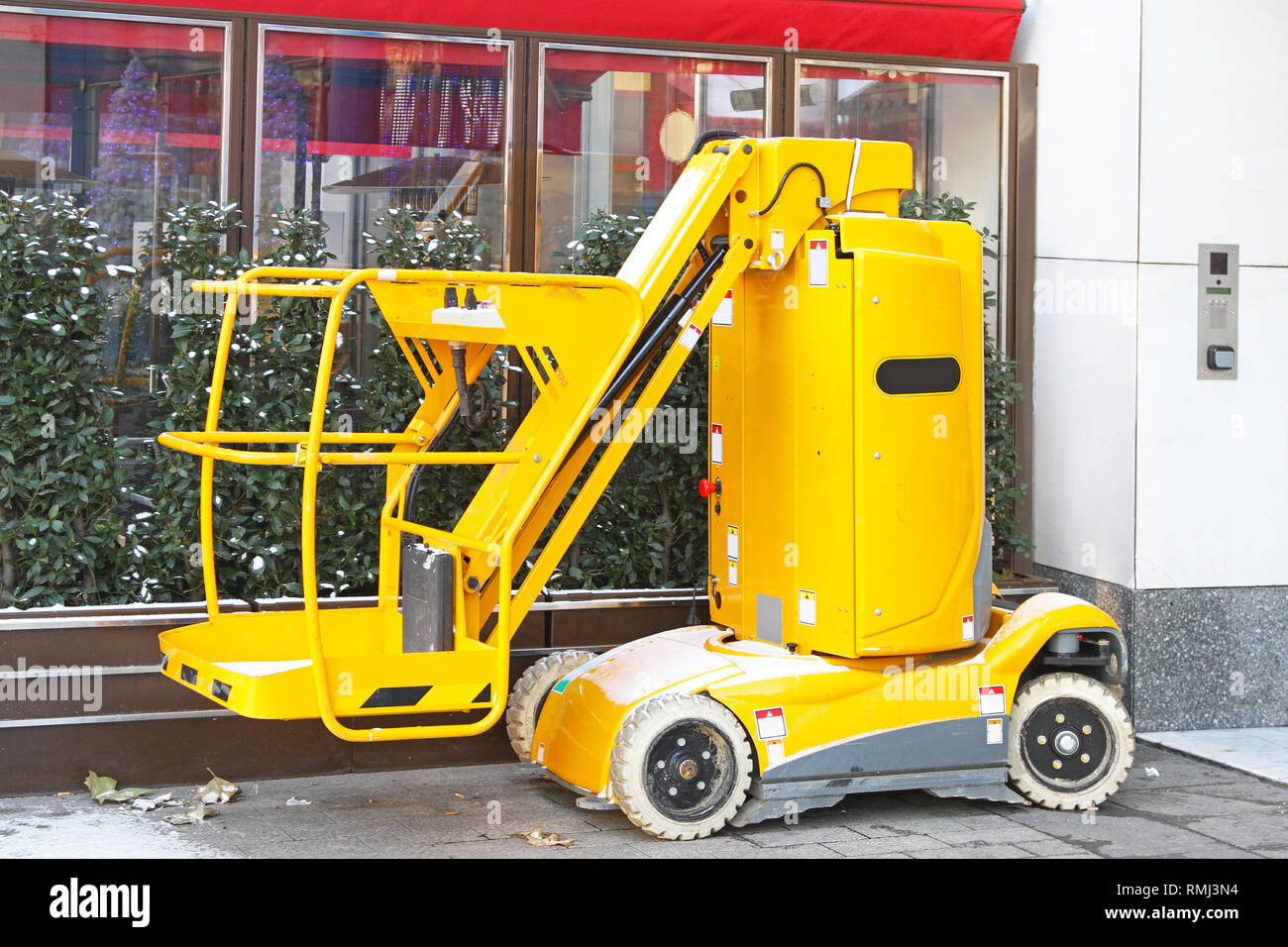 Yellow hydraulic lift platform mobile utility vehile Stock Photo - Alamy