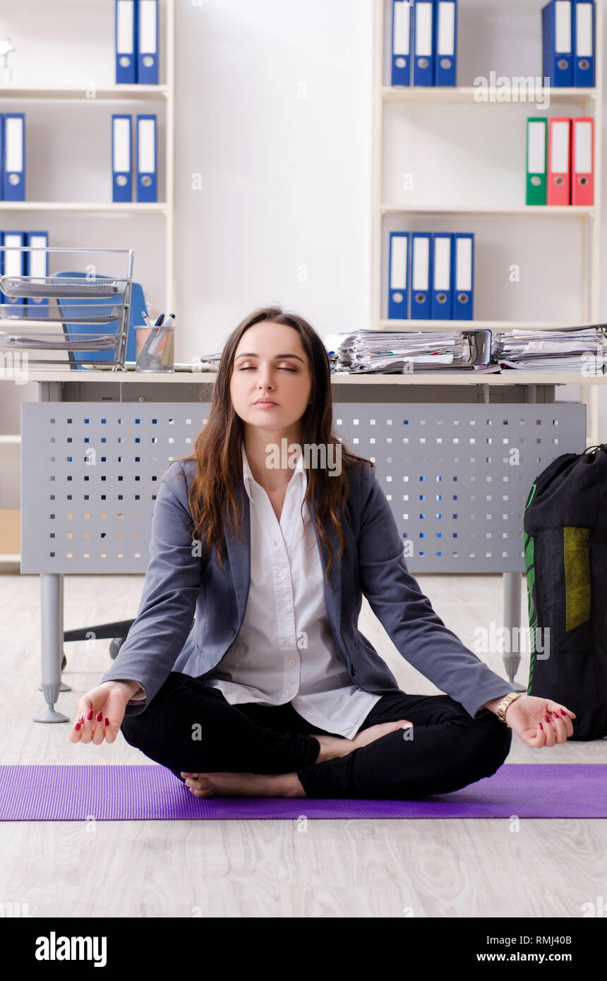 Female employee doing sport exercises in the office Stock Photo - Alamy