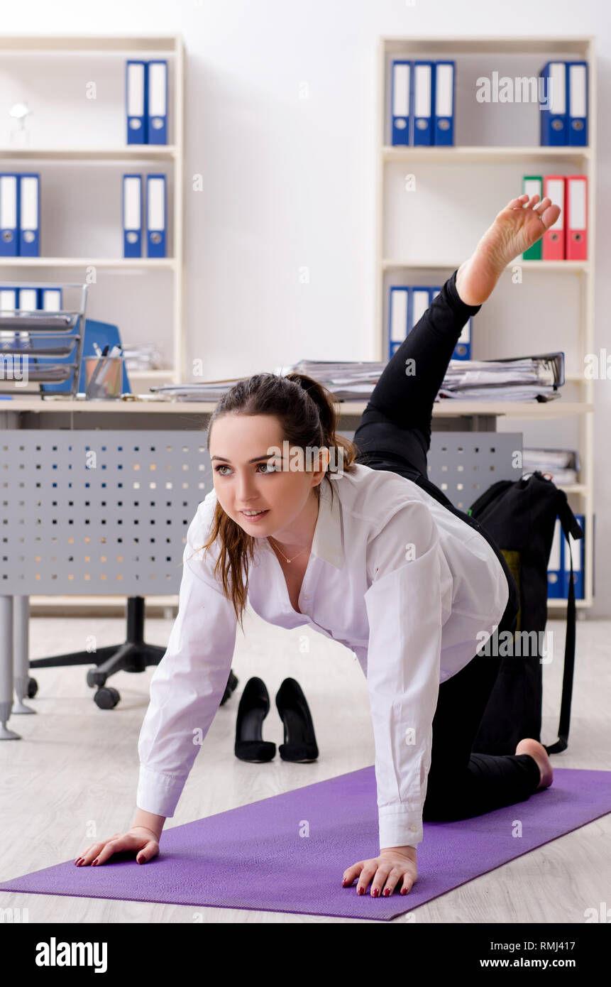 Female employee doing sport exercises in the office Stock Photo - Alamy