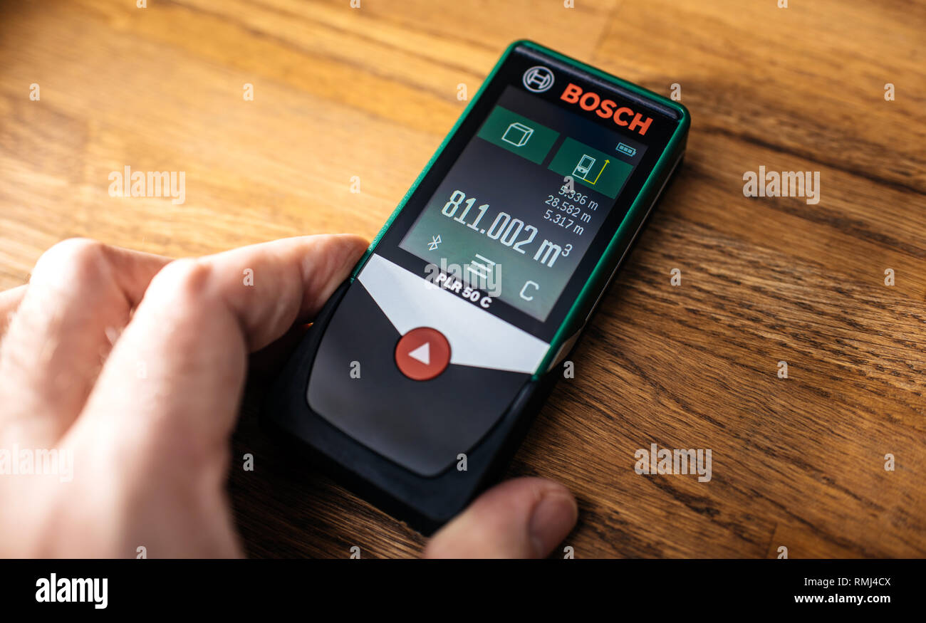 PARIS, FRANCE - JAN 19, 2018: Male hand accurate laser meter ...