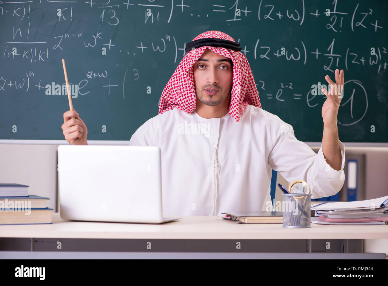 Arab teacher in front of chalkboard Stock Photo - Alamy