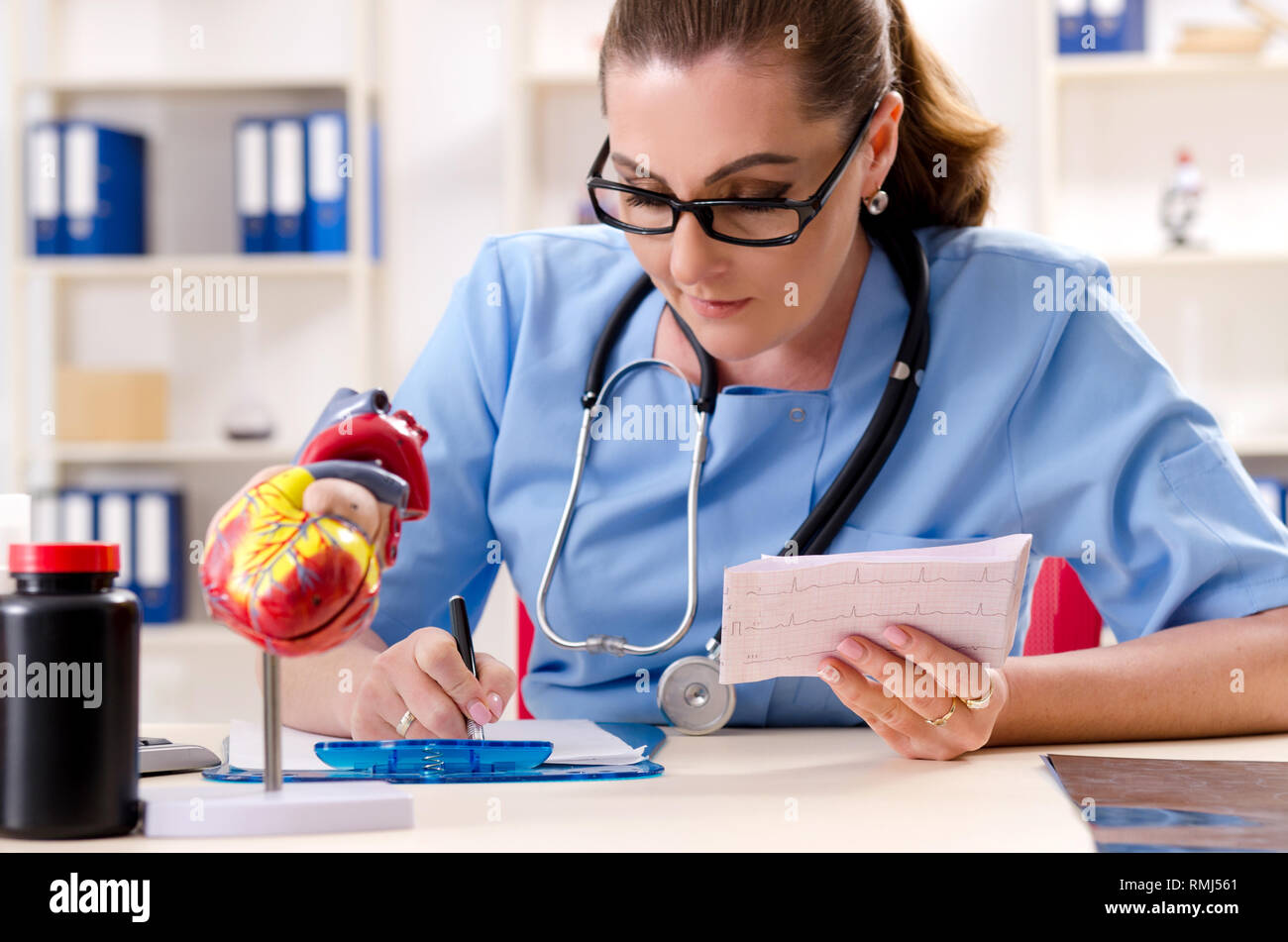 Female doctor cardiologist working in the clinic Stock Photo - Alamy