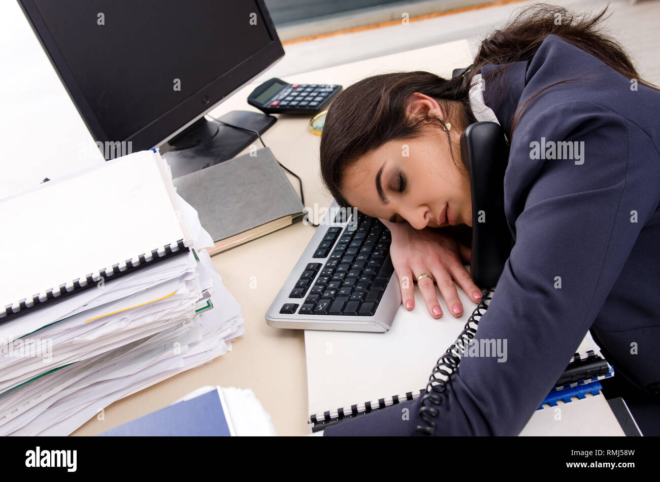 Female employee with too much work in the office Stock Photo - Alamy