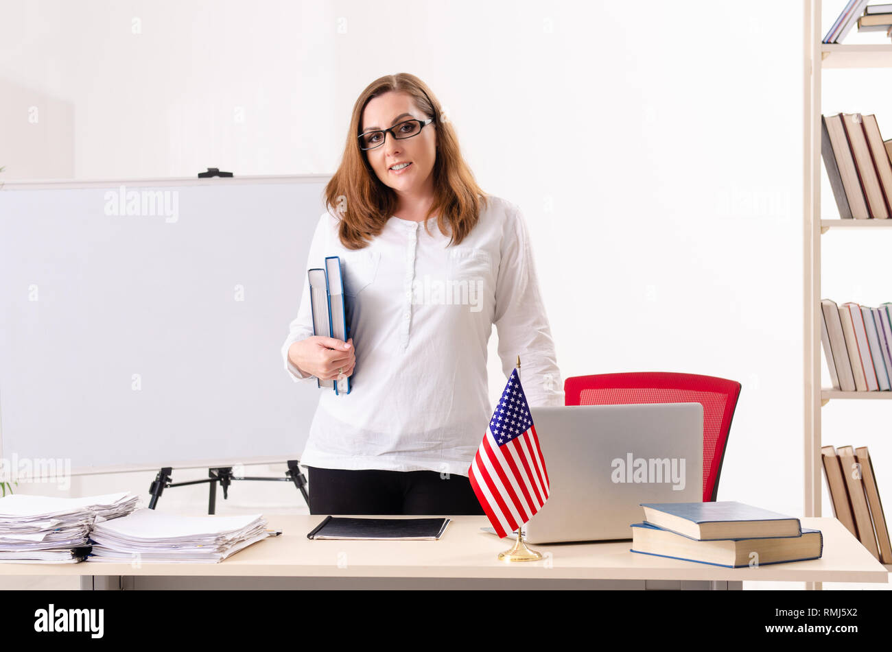 Female english teacher in the classroom Stock Photo - Alamy