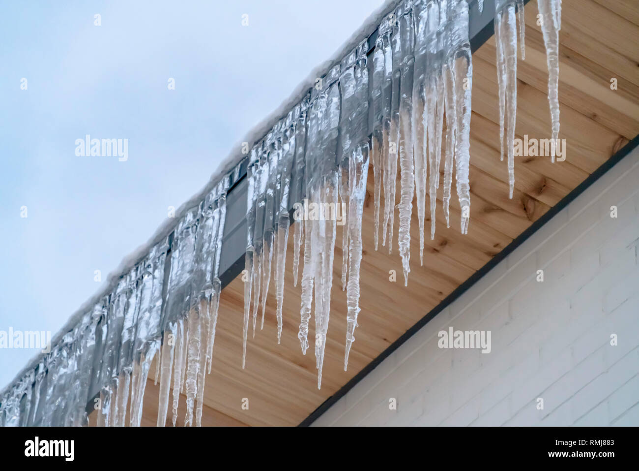 Sharp icicles on the eaves of a roof in Utah Stock Photo - Alamy