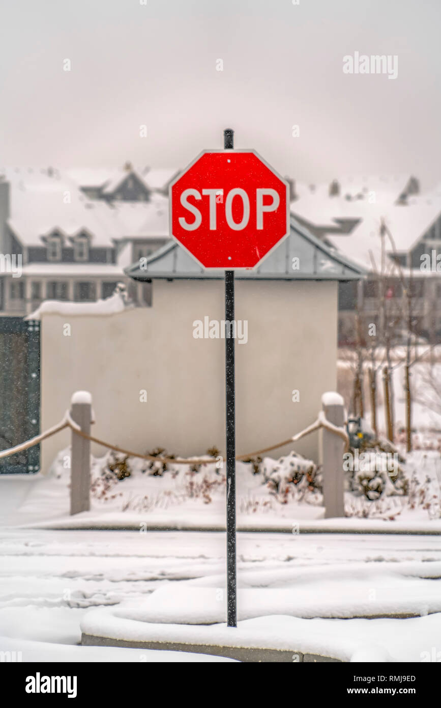 Stop sign on a snow covered road in Daybreak Utah Stock Photo - Alamy