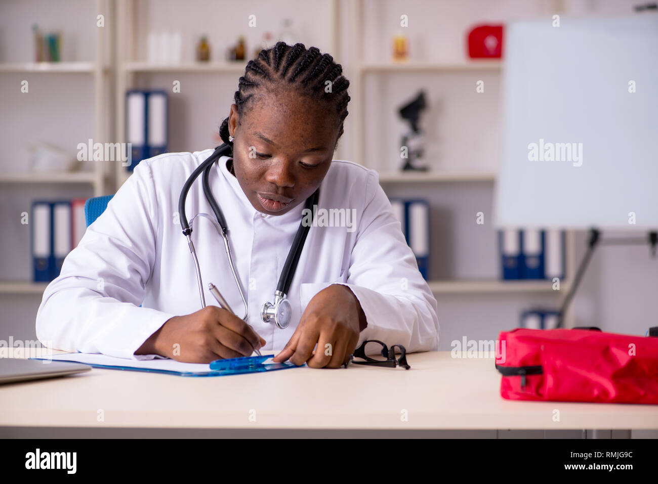 Black female doctor working at clinic Stock Photo - Alamy