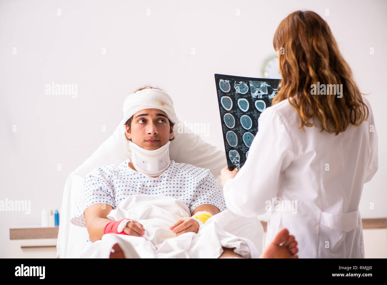 Young doctor examining injured patient Stock Photo - Alamy