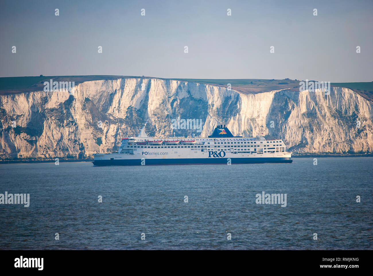 A ferry passing next to the white cliffs of Dover in the English ...