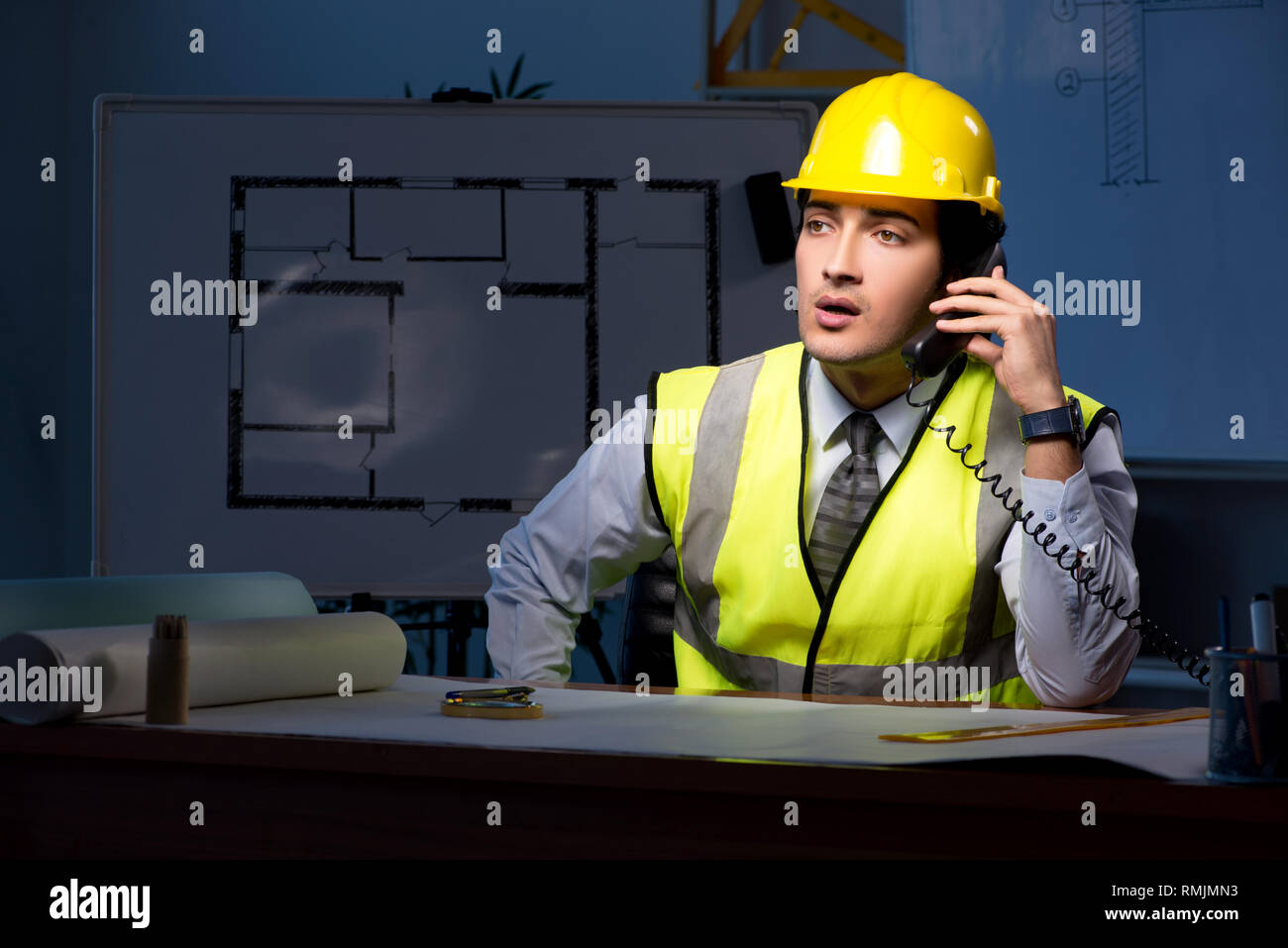 Young construction architect working on project at night Stock Photo ...