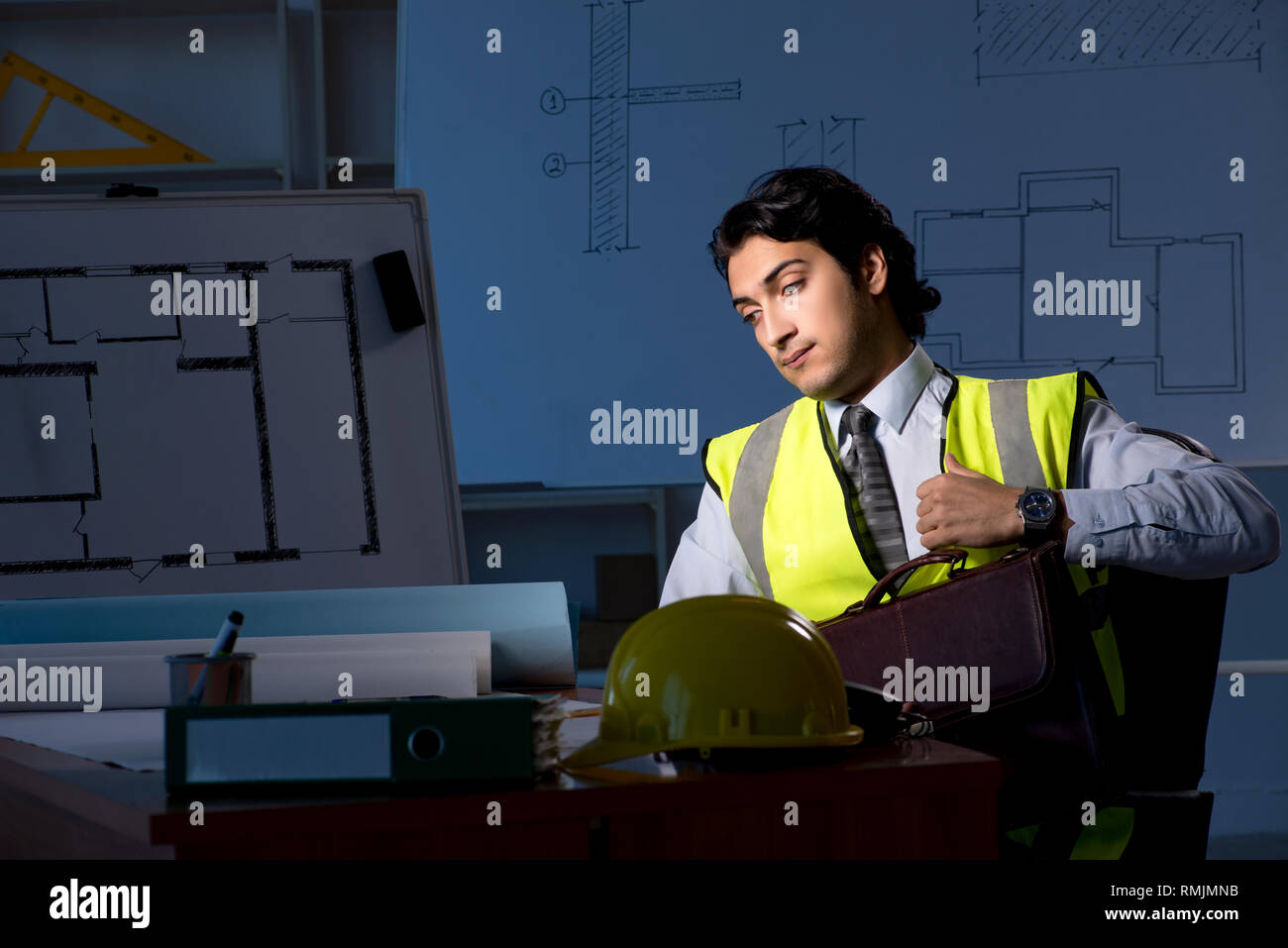 Young construction architect working on project at night Stock Photo ...