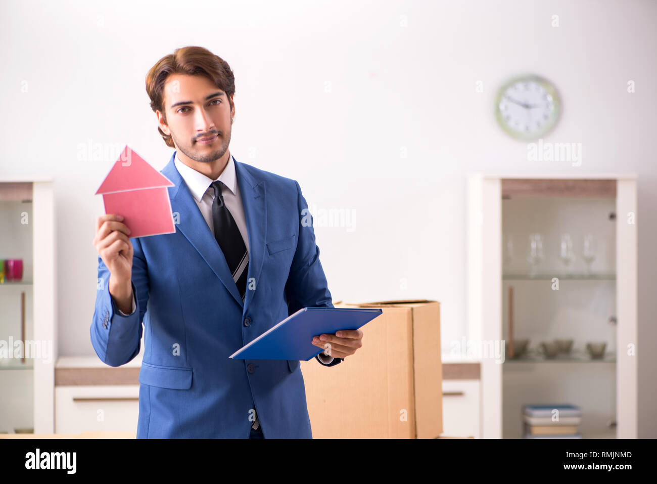 Young handsome realtor selling flat Stock Photo - Alamy