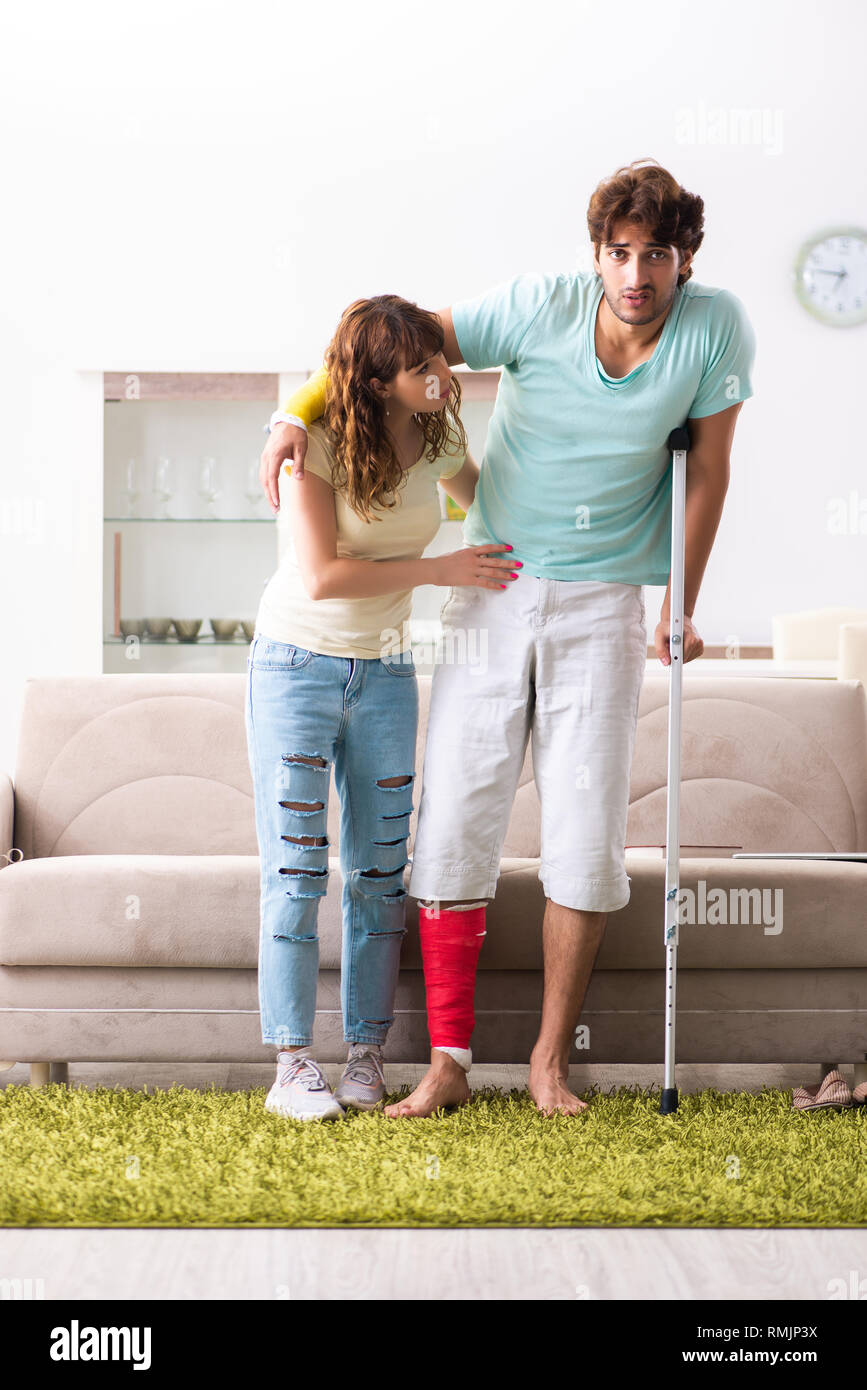 Young family helping each other after injury Stock Photo - Alamy