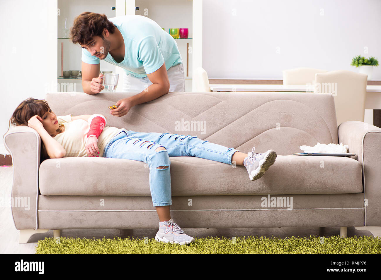 Young family helping each other after injury Stock Photo - Alamy