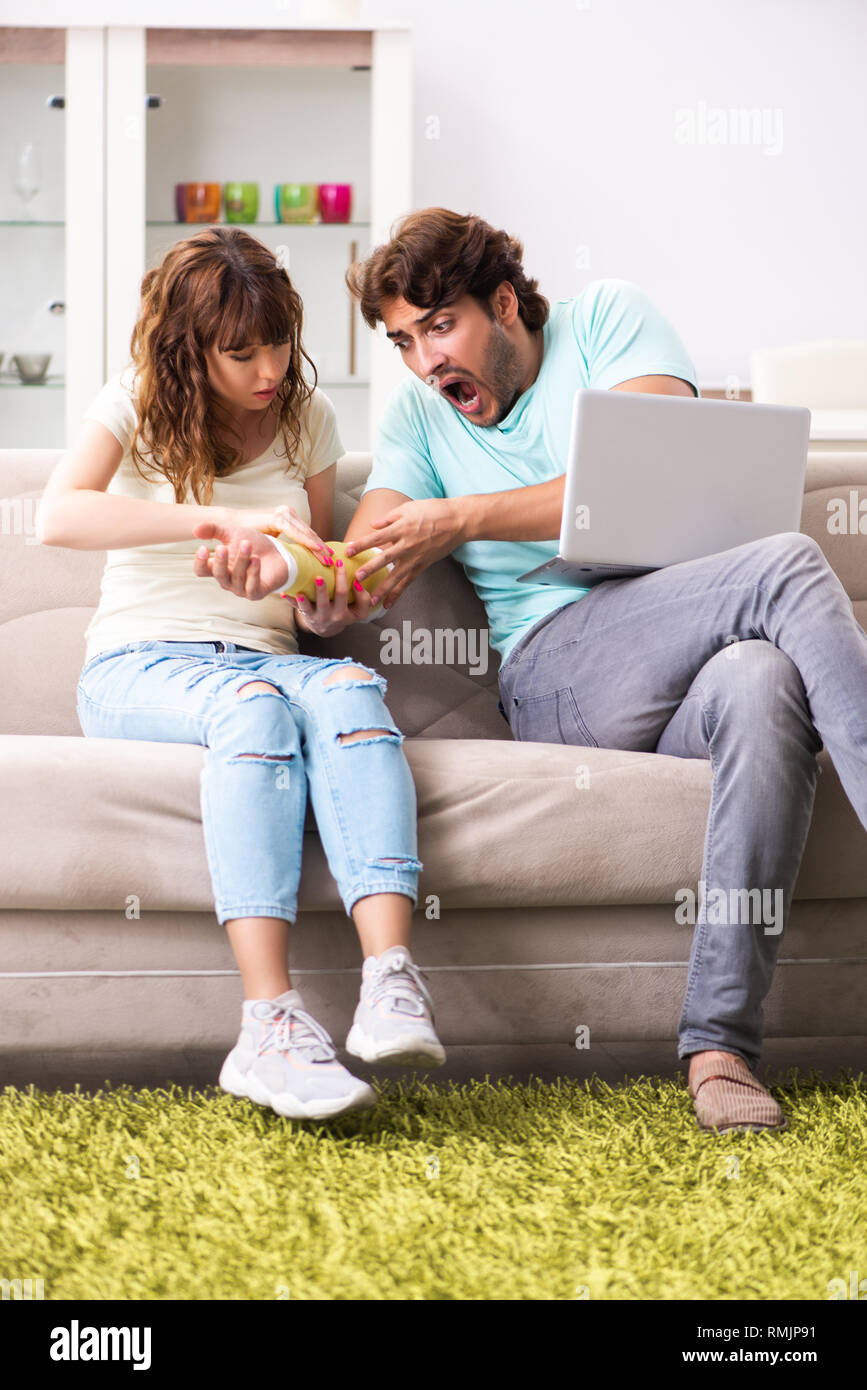 Young family helping each other after injury Stock Photo - Alamy