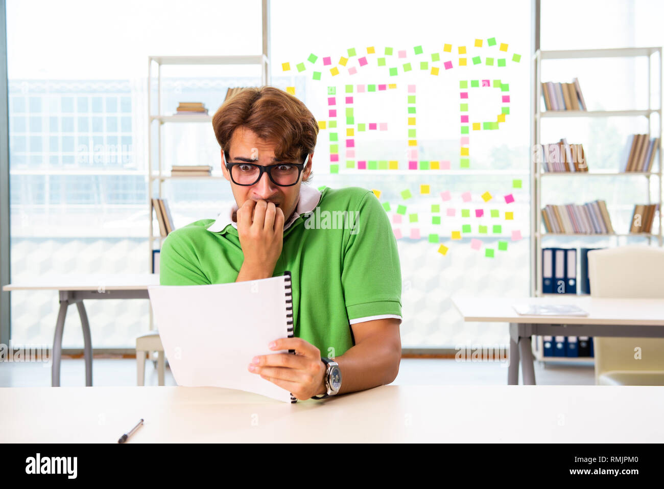 Student struggling at the exam in classroom Stock Photo - Alamy