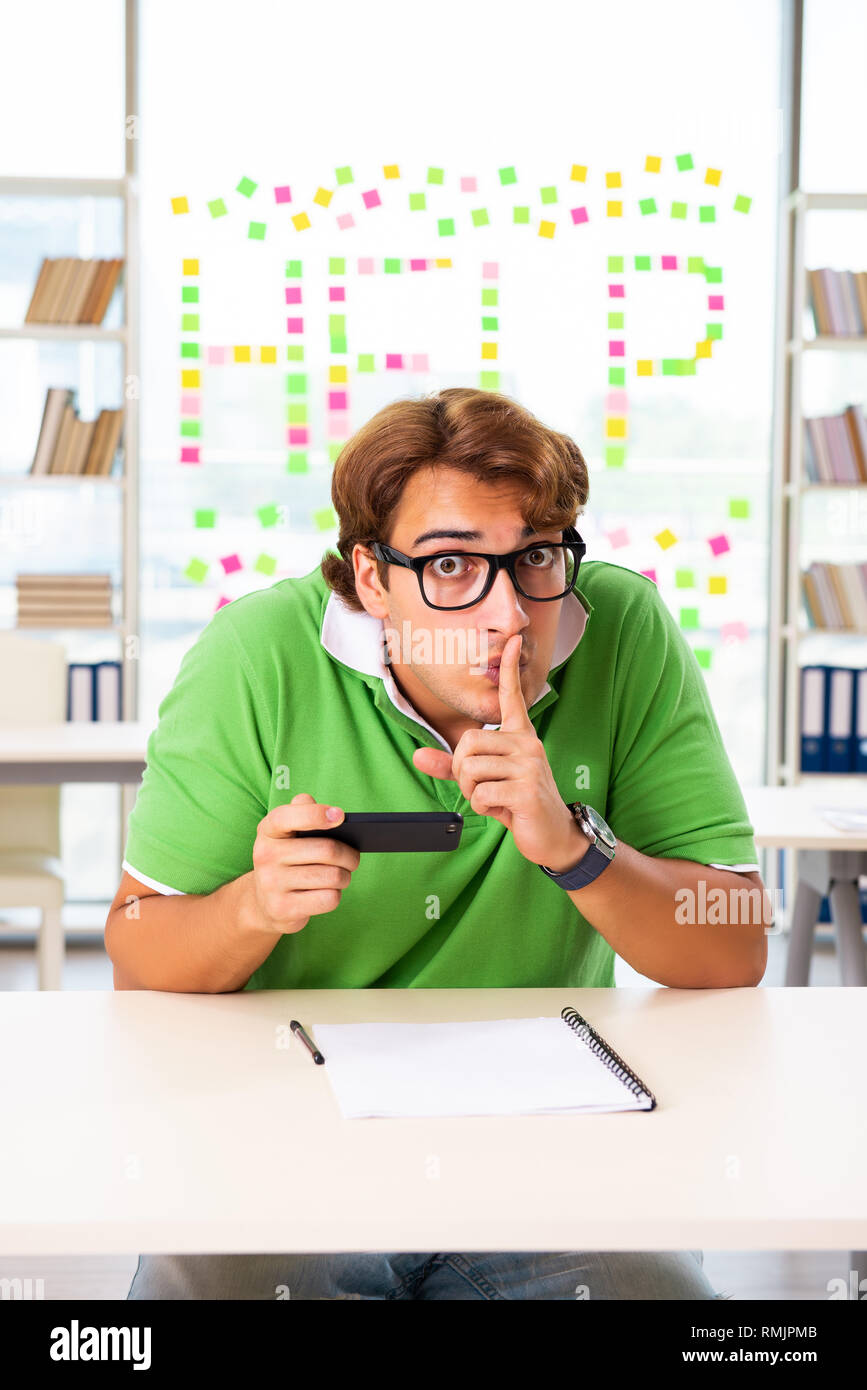 Student struggling at the exam in classroom Stock Photo - Alamy