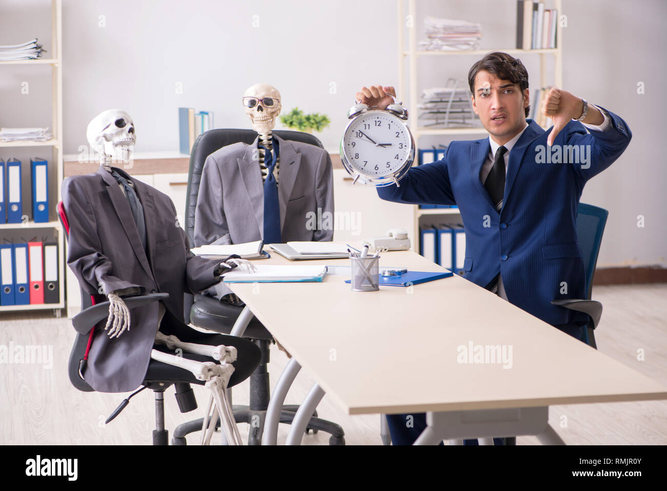 Funny business meeting with boss and skeletons Stock Photo - Alamy