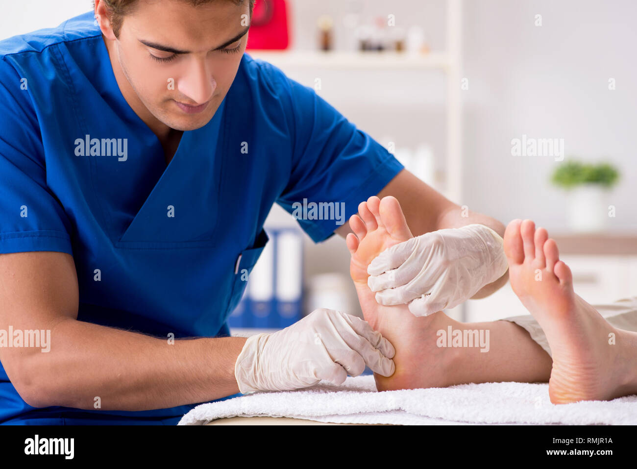 Podiatrist treating feet during procedure Stock Photo - Alamy