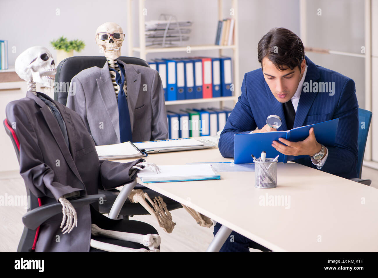 Funny business meeting with boss and skeletons Stock Photo - Alamy
