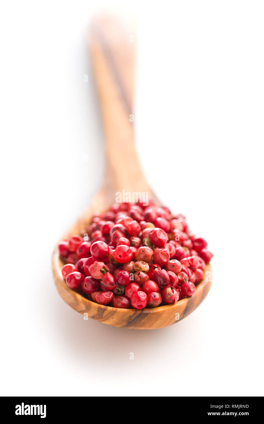 Dried pink peppercorn in wooden spoon isolated on white background ...